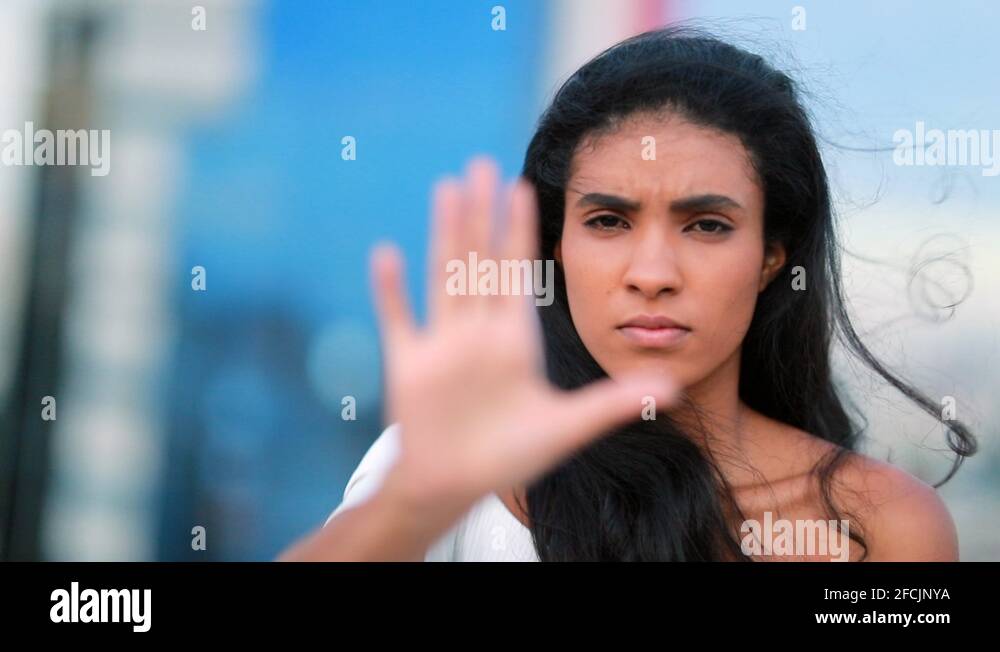 Defensive black woman with her hand extended signaling to stop Stock ...