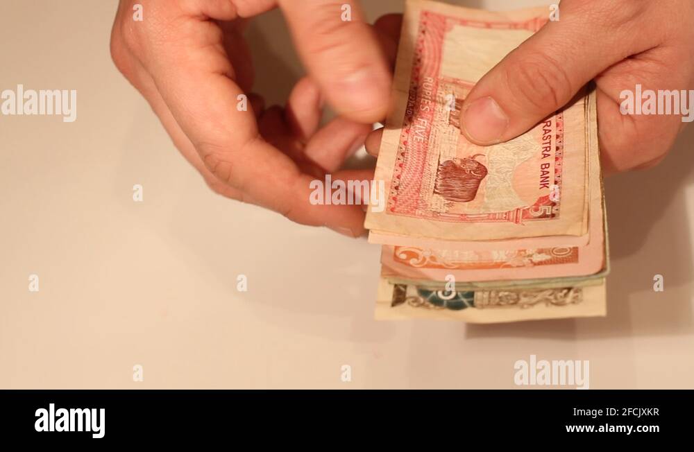 Man's hands counting Nepalese Rupee banknotes. National Currency of ...