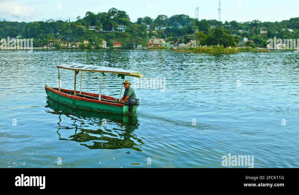 Ferryman on his tourist boat on a lake in Central America Stock Video ...