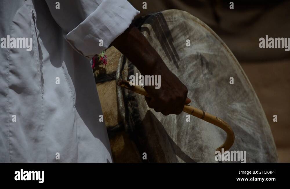 Berbere musician playing tradicional drum in the Sahara Desert, Marocco ...