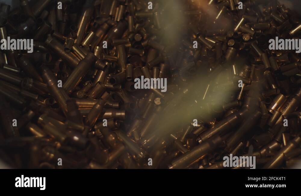 Empty shell casings being dumped in barrel of spent ammo casings Stock ...