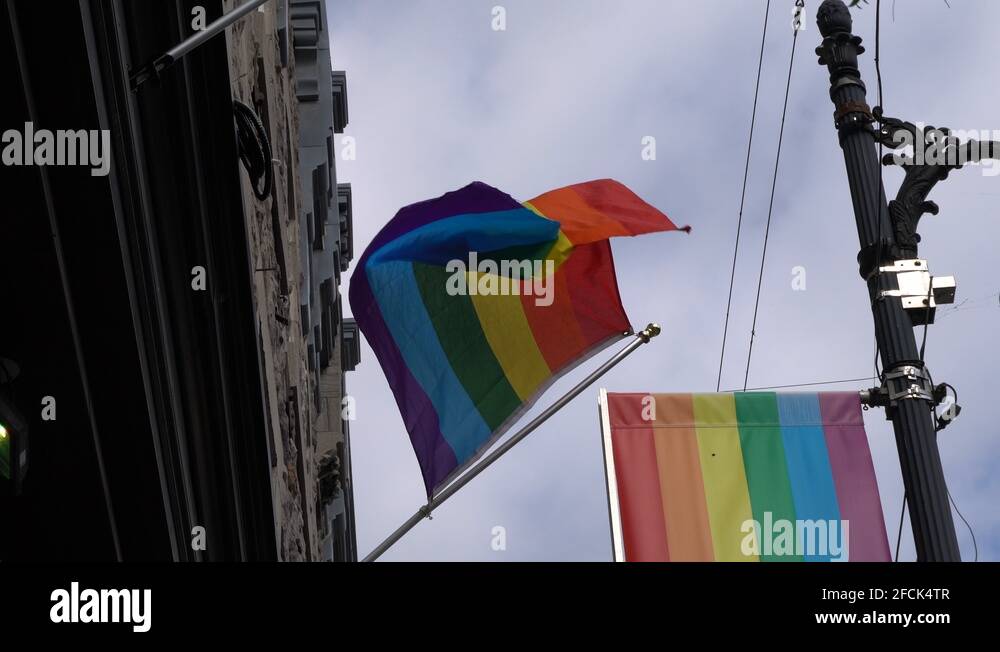 The pride flag ising fast with a strong wind effect. The flag is in ...