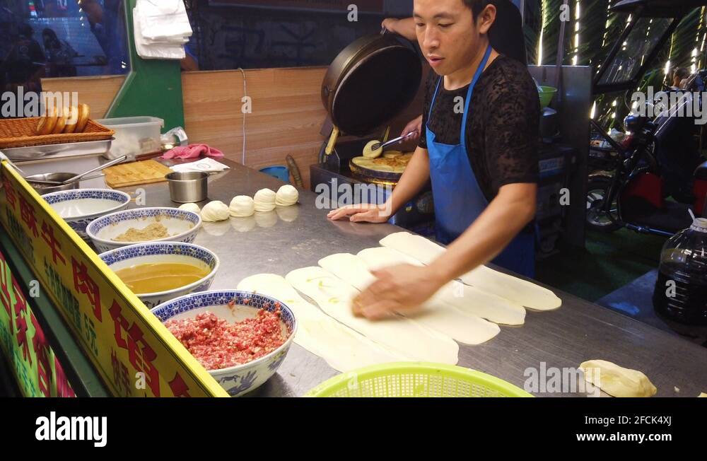 Xian, China - August 2019 : Man making minced beef meat filled pastries ...