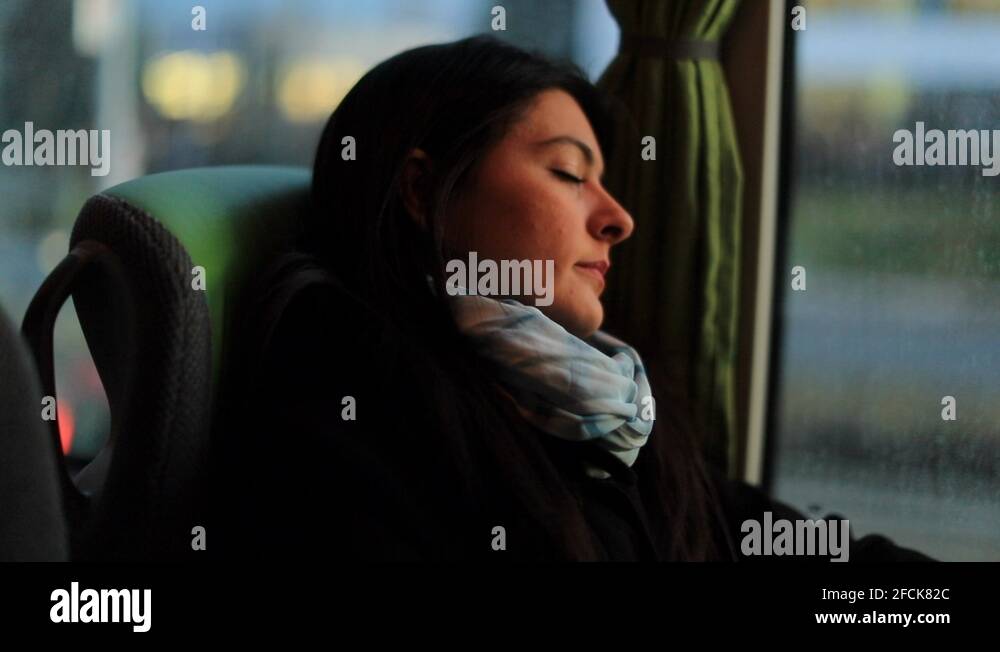 Passenger asleep while traveling by bus. Girl sleeping while riding ...