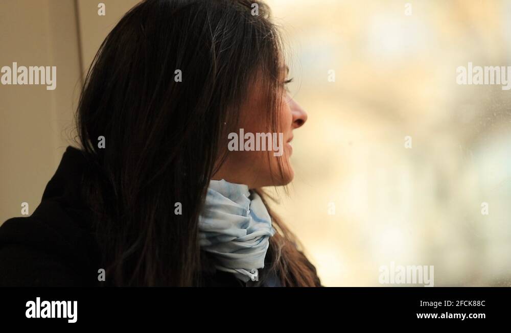 Girl stares outside window while on a moving wagon train. Happy ...