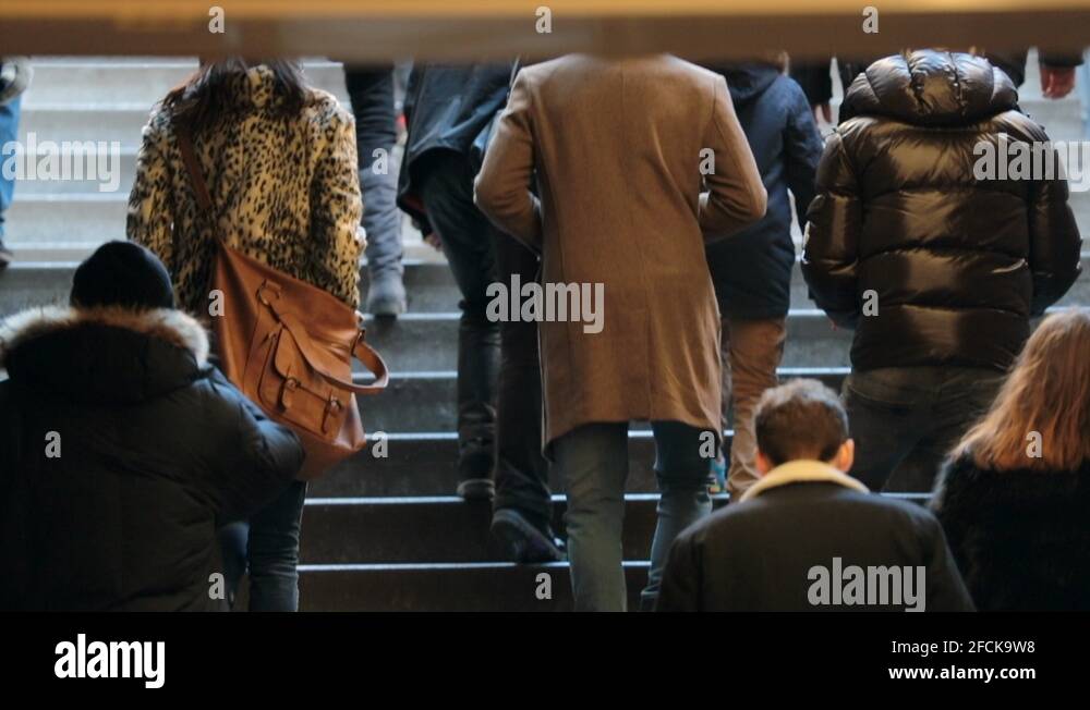 Crowd of people going up the stairs to the city surface. People leaving ...