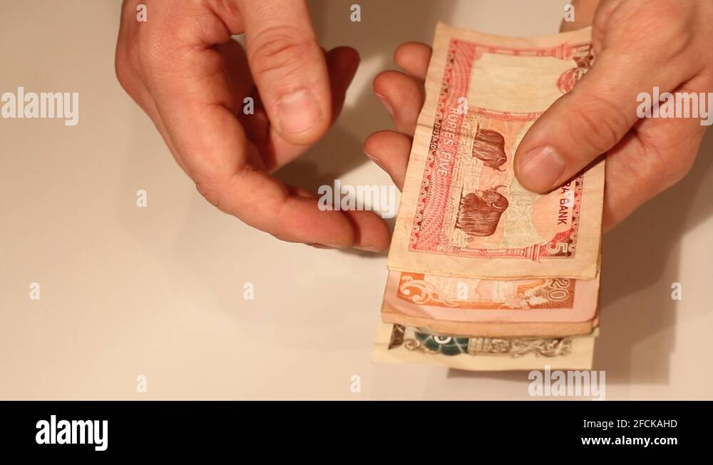 Man's hands counting Nepalese Rupee banknotes. National Currency of ...