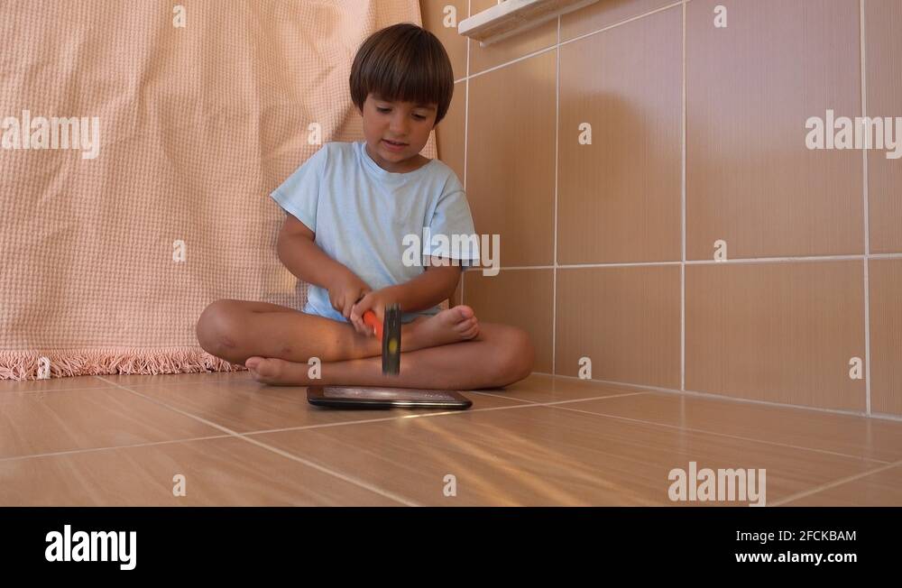 Inquisitive kid breaks his tablet PC with a hammer to see what is ...