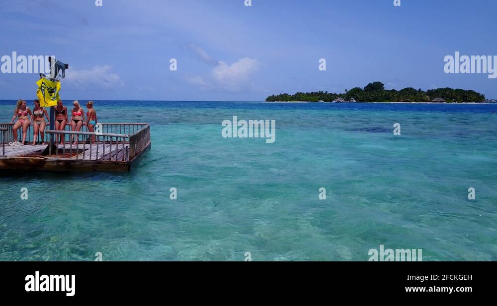 Women Sunbathing on a Raft at their hotel resort in the Maldives Stock ...