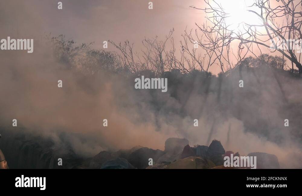 Smog smoke fog rises from a trash fire air pollution environment Stock ...