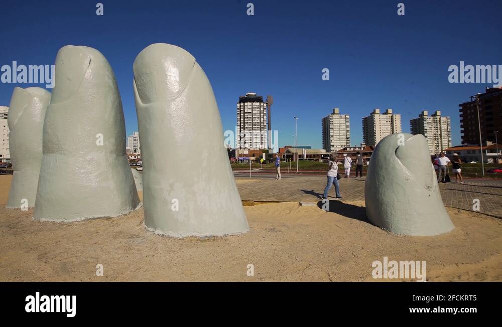 Orbital footage of The Hand statue in Punta del Este with city ...