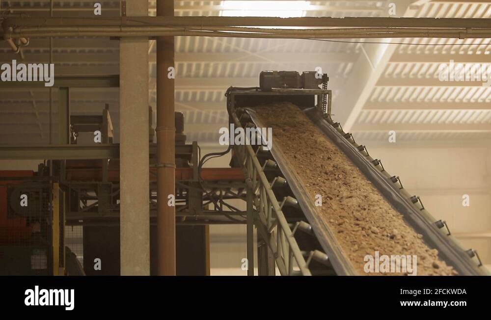 Machines working and conveyor line transporting sand. Conveyor belt on ...