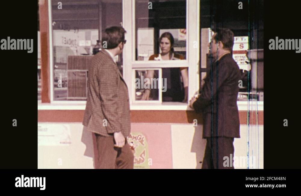 1970s: UNITED STATES: officers interview people in neighbourhood. Men ...