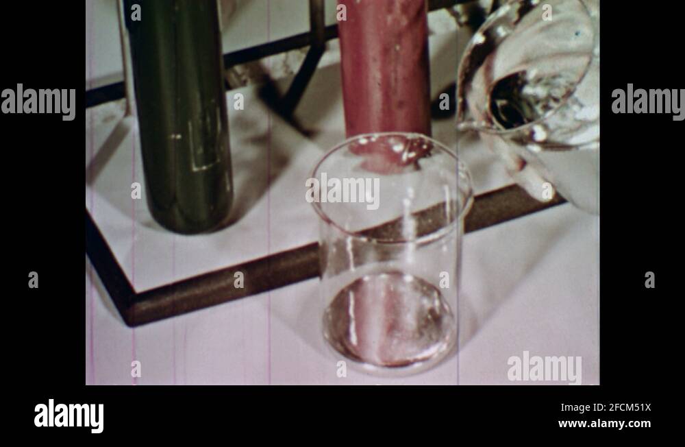 1950s: pouring liquid into empty beaker in front of canisters of ...