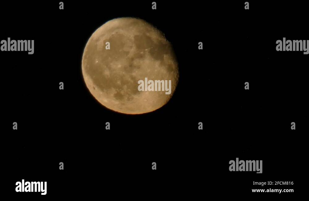 Apocalyptic ominous blood moon rising slowly across dark night sky ...