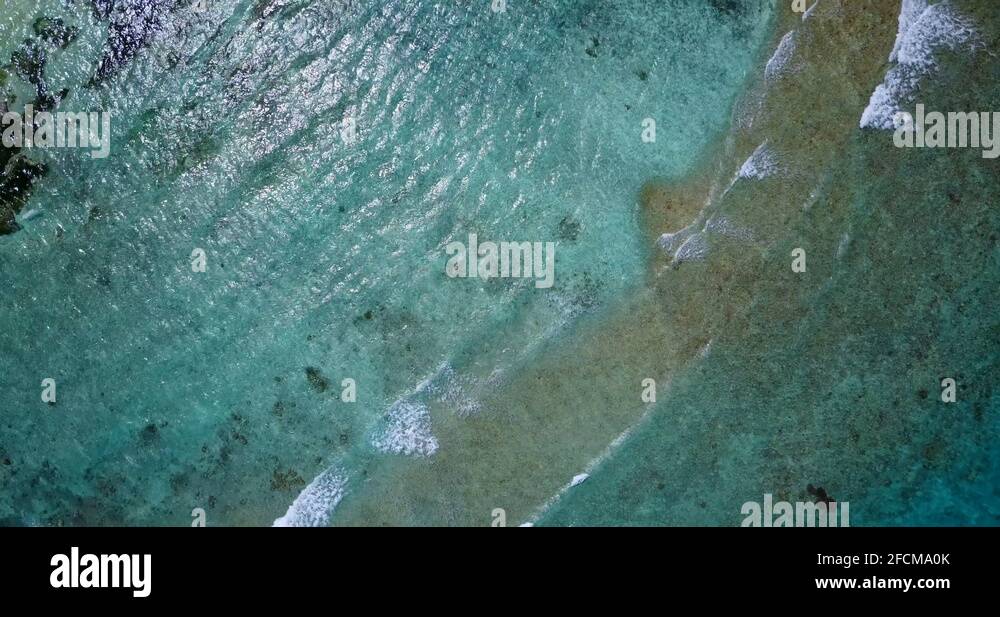 Green color palette of a rotating top view over long white waves ...