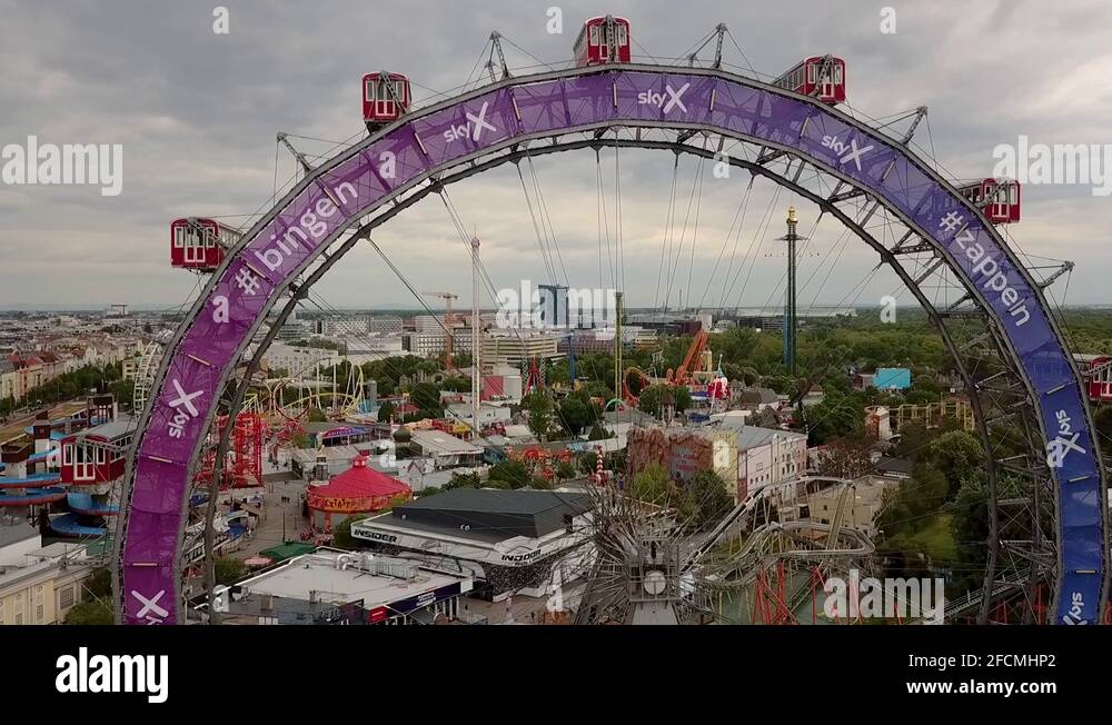 wiener riesenrad rotating ferris wheel in vienna crowded city, aerial ...