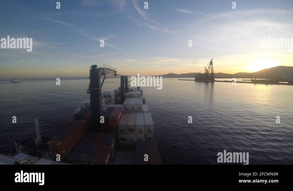 Container ship have bunkering during anchorage. Sunset at Gibraltar Bay ...