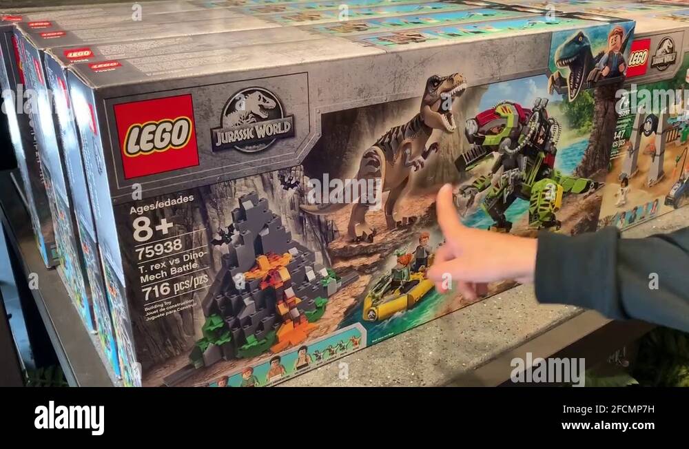 Small finger pointing at a newly released Jurassic World LEGO box at a ...
