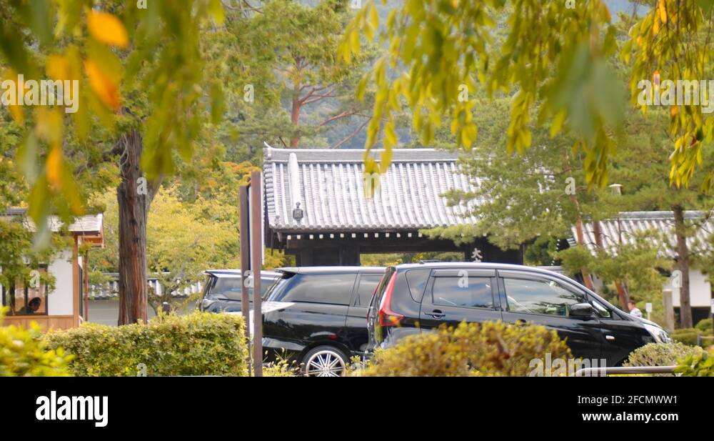 Cars parked outside of a gate surrounded by green in Kyoto, Japan 4K ...