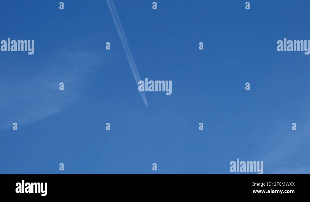 4K Airplane jet stream on a clear blue sky background Stock Video ...