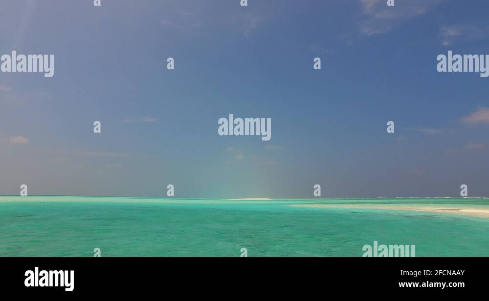 Pull back shot with tilt down of a perfectly clean beach in the ...