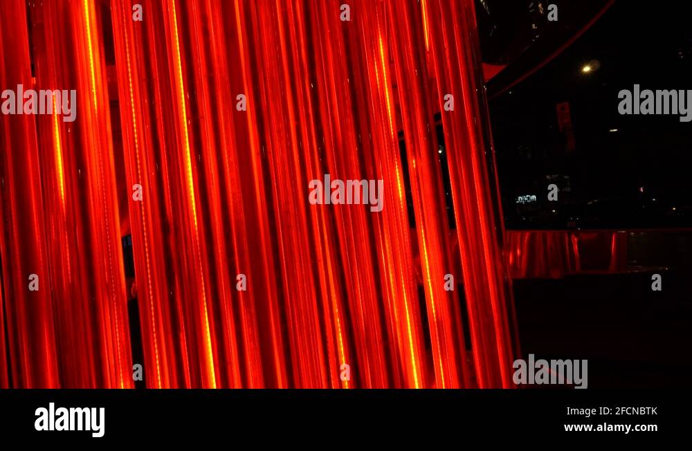 A pattern of red light effects that creates art at night. You can see ...