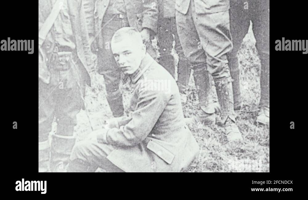 1950s: Soldier sitting on ground. Two men look over airplane. Soldiers ...