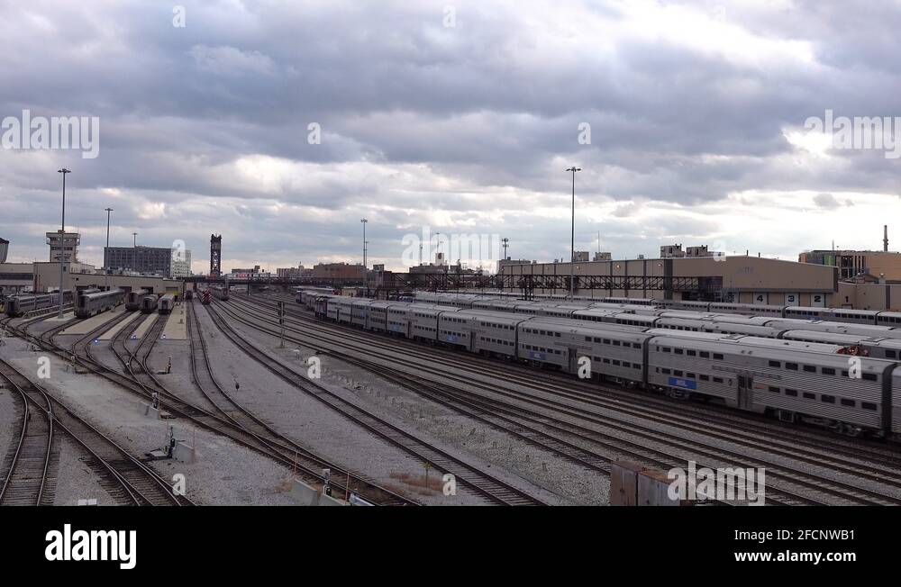 a passenger train and locomotive leaving rail yard 4k Stock Video ...