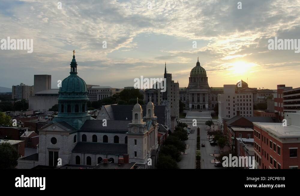 Rising aerial of PA Capitol Dome, State Museum, houses of worship at ...