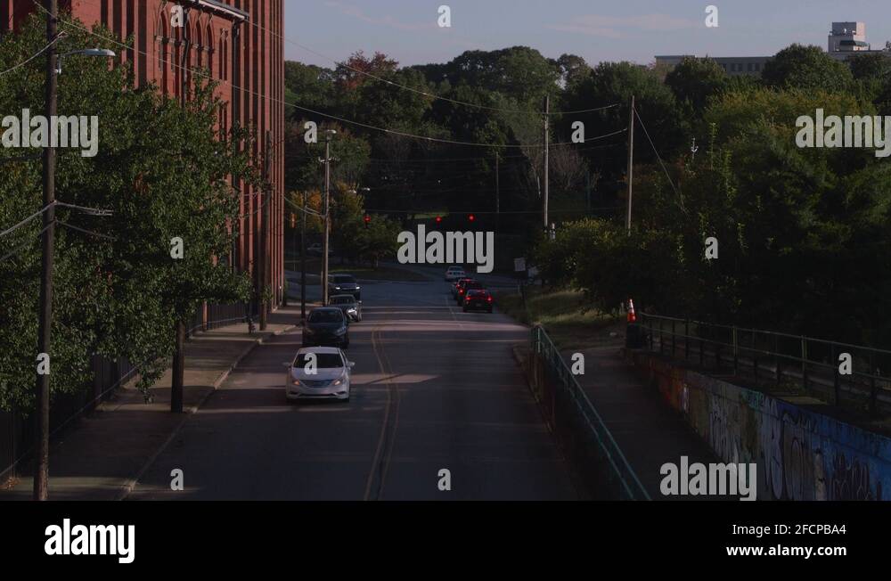cars passing by on a busy street. traffic light blinking red Stock ...