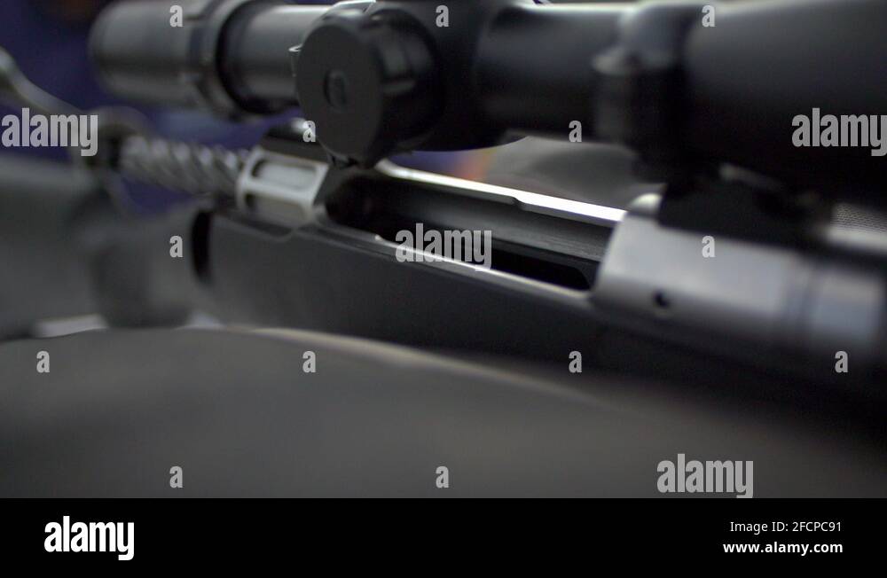 Loading a bullet in a gun on a rifle Stock Video Footage - Alamy