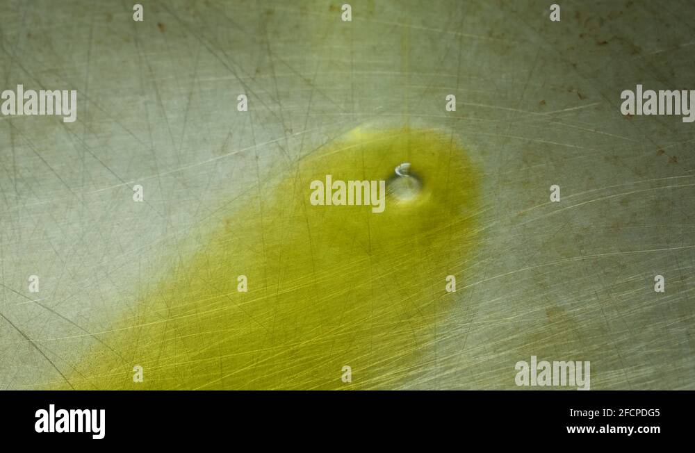 Cooking oil dripping into a steel basin Stock Video Footage - Alamy