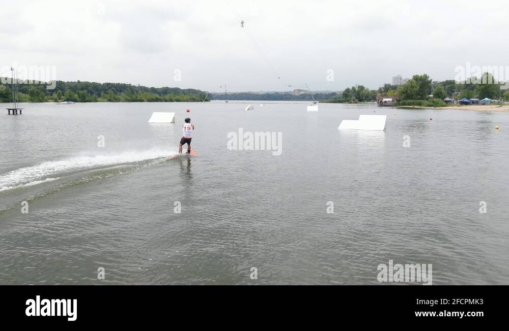 Splashes of water after a massive jump off the ramp by a wakeboarder ...