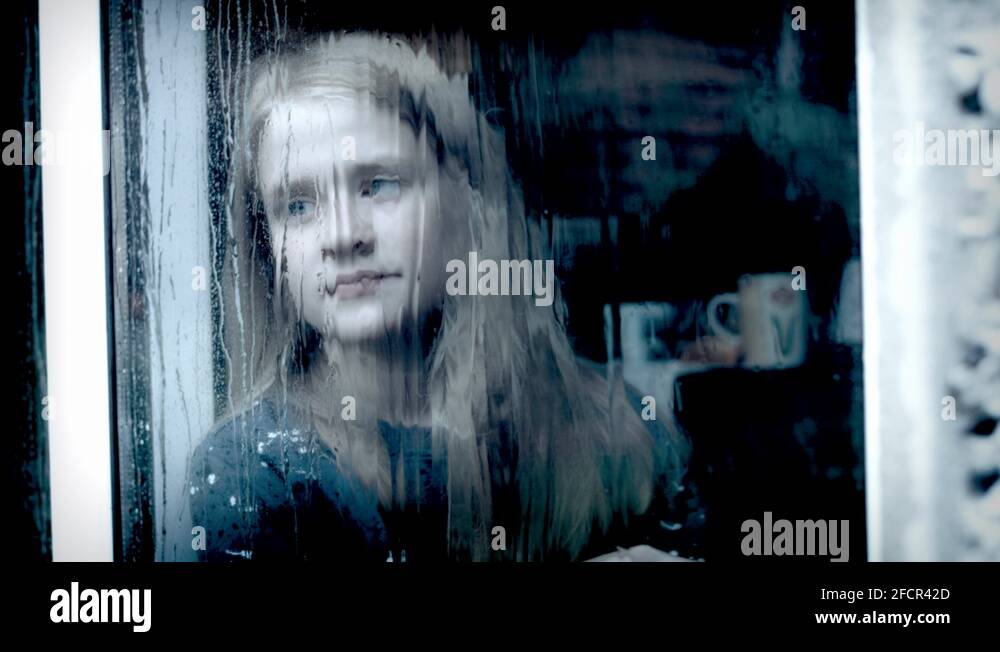 4k Sad Child Girl Looking through the Glass while Raining Stock Video ...