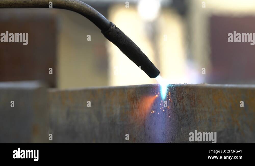 Cutting a steel profile with an acetylene torch. Heating a steel ...