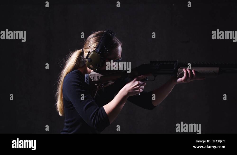 Side View of Woman Shooting Pump-Action Shotgun in Shooting Range in ...