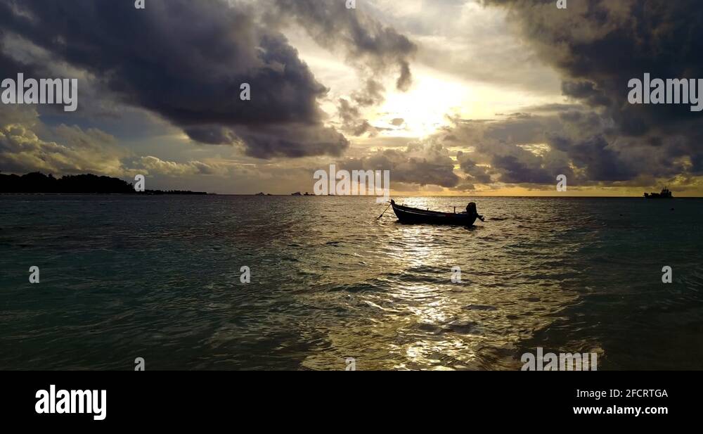 Cinematic background of fishing boat waving on shallow lagoon water ...