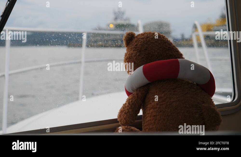 Cute teddy bear sitting on a ship wearing a lifebelt. Mascot of a boat ...