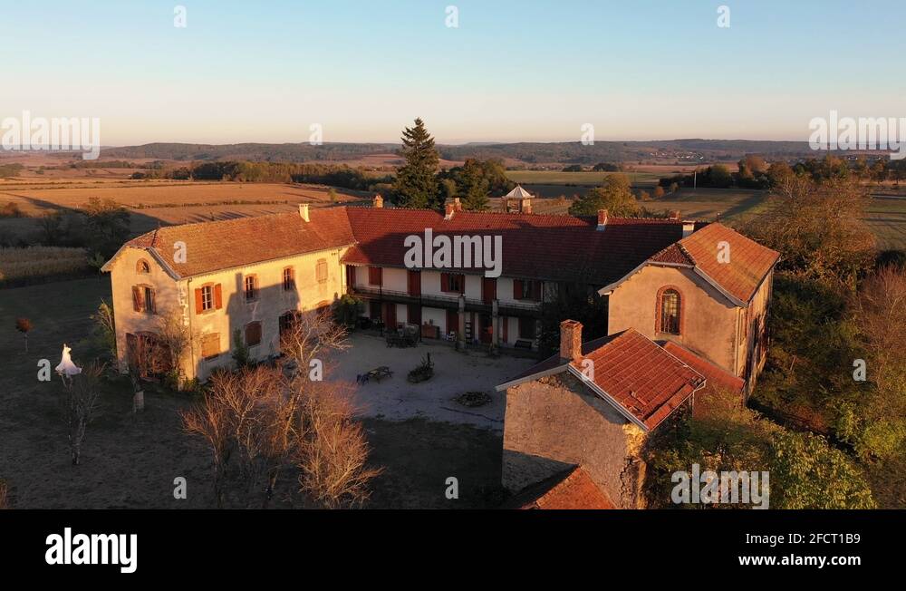 Big house, mansion, chateau lit by the sun at sunset. Enormous estate ...