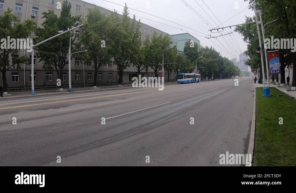 Public bus travelling along Sungri Street and stopping at an ...