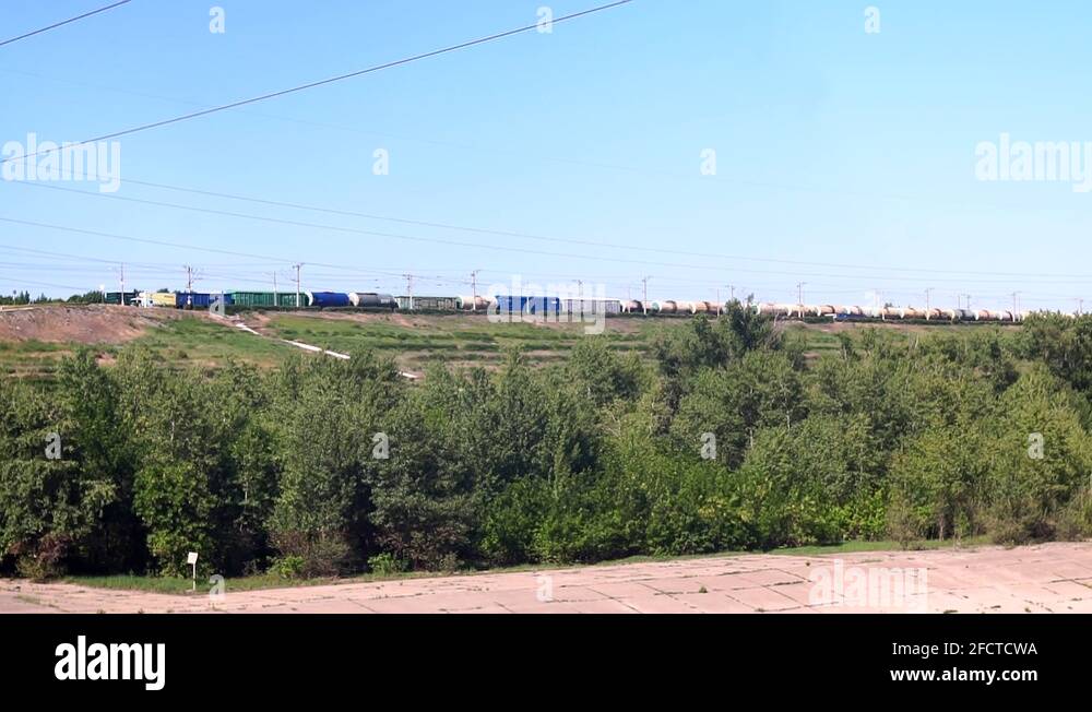 long freight train with building materials is moving by railway on the ...