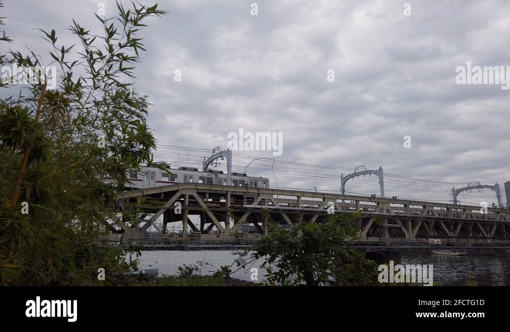 Tobu Isesaki Line train crossing Sumida river near Tokyo Skytree in ...