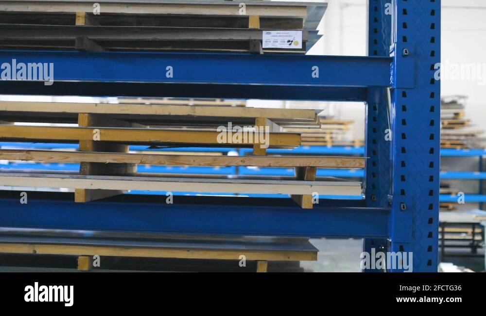 Inside view of a industrial warehouse with blue shelves and palettes ...