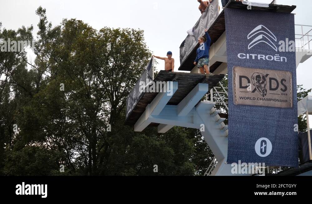 Young boy does a "death dive" from a high platform into the pool below ...