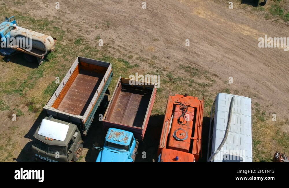 Old soviet trucks stand broken on the collective farm. Copter ( drone ...