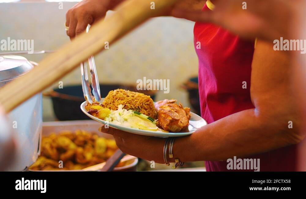 Woman adding food to plate from buffet bar Stock Video Footage - Alamy