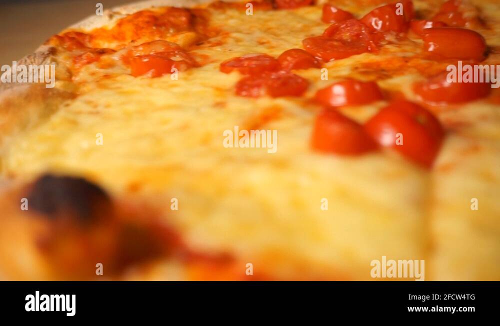Close up of homemade pizza , camera panning from left to right,side ...