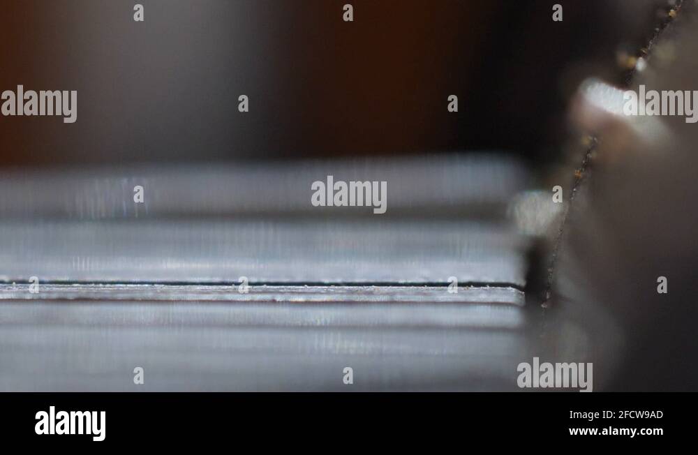 Extreme macro side view of the internal mechanism inside an old music ...