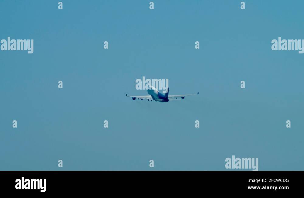 A big wide body aircraft climbing out after take off. Blue sky ...